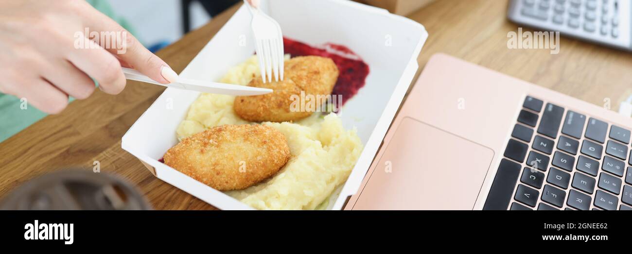 Woman and man eating from cardboard plates with disposable plastic fork ...