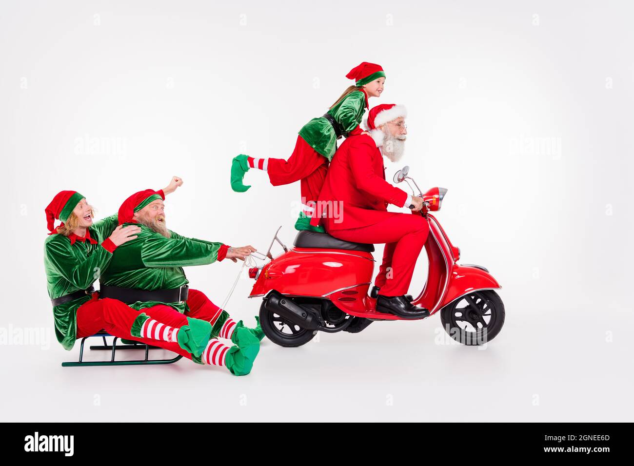 Portrait of attractive cheerful friends riding motor bike carrying ...