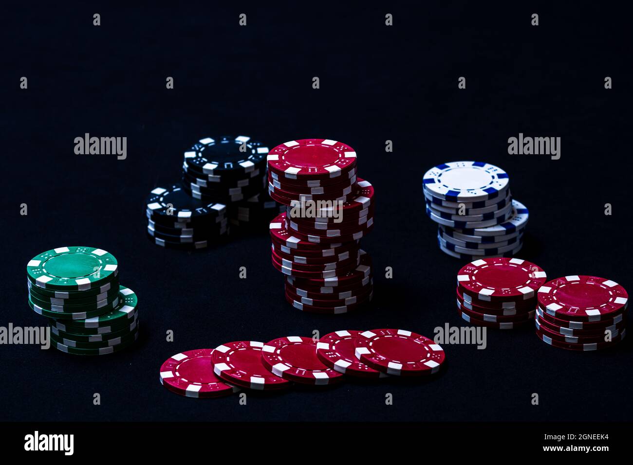 Stack of poker chips on black background Stock Photo - Alamy