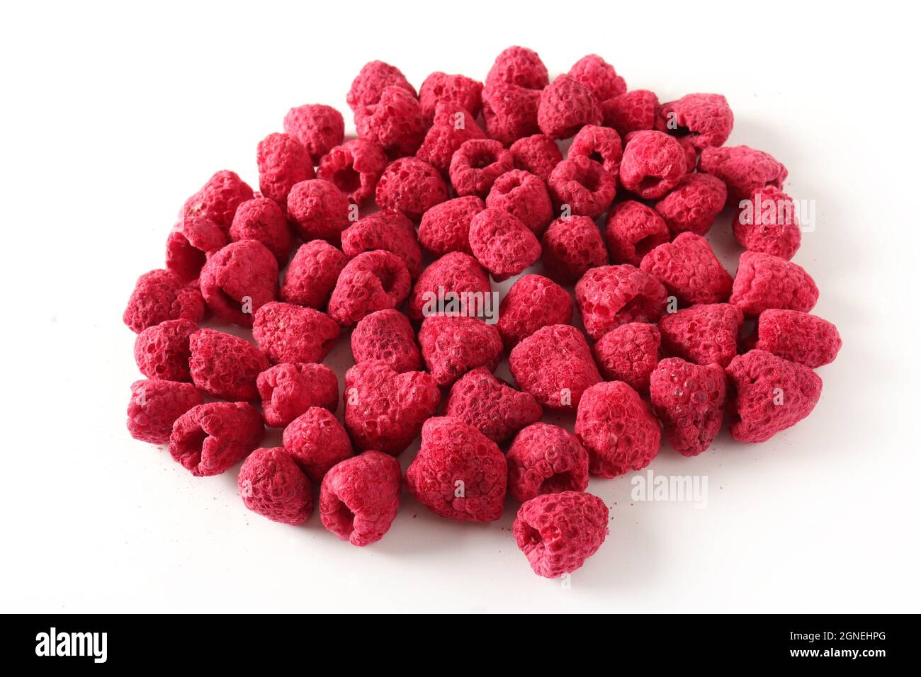 freeze dried raspberries on a white background Stock Photo - Alamy
