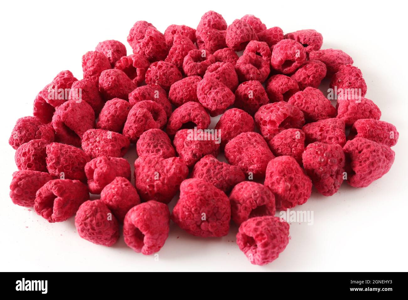 freeze dried raspberries on a white background Stock Photo - Alamy