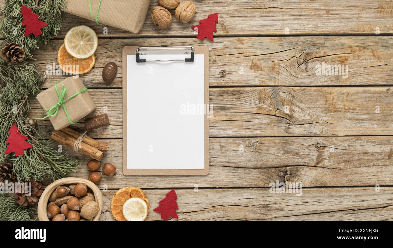 flat lay festive christmas table arrangement with empty clipboard copy ...