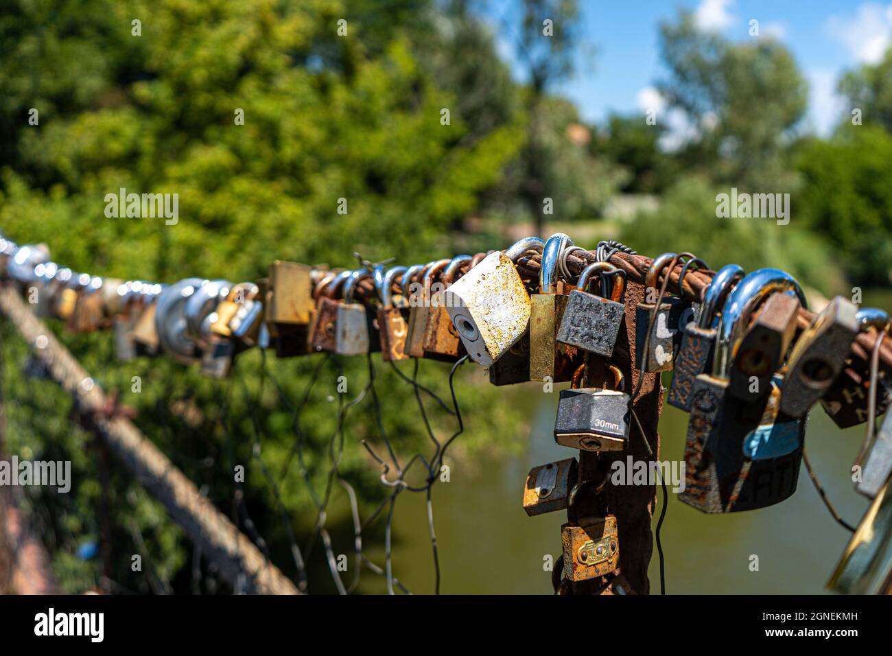 Different coloured locks left on the wire railing of a 100 year old ...