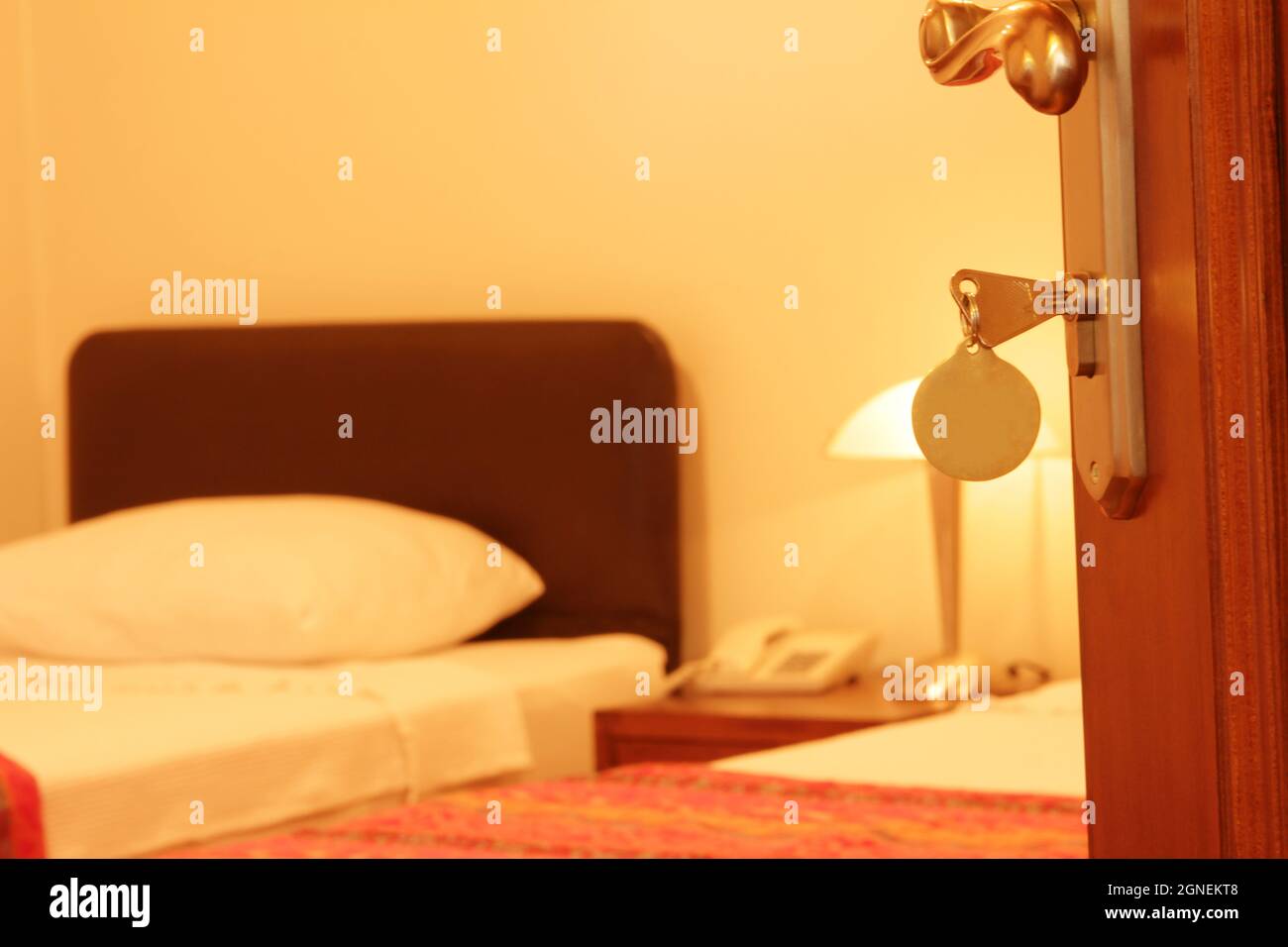 Modern hotel room, open door and phone on desktop Stock Photo - Alamy