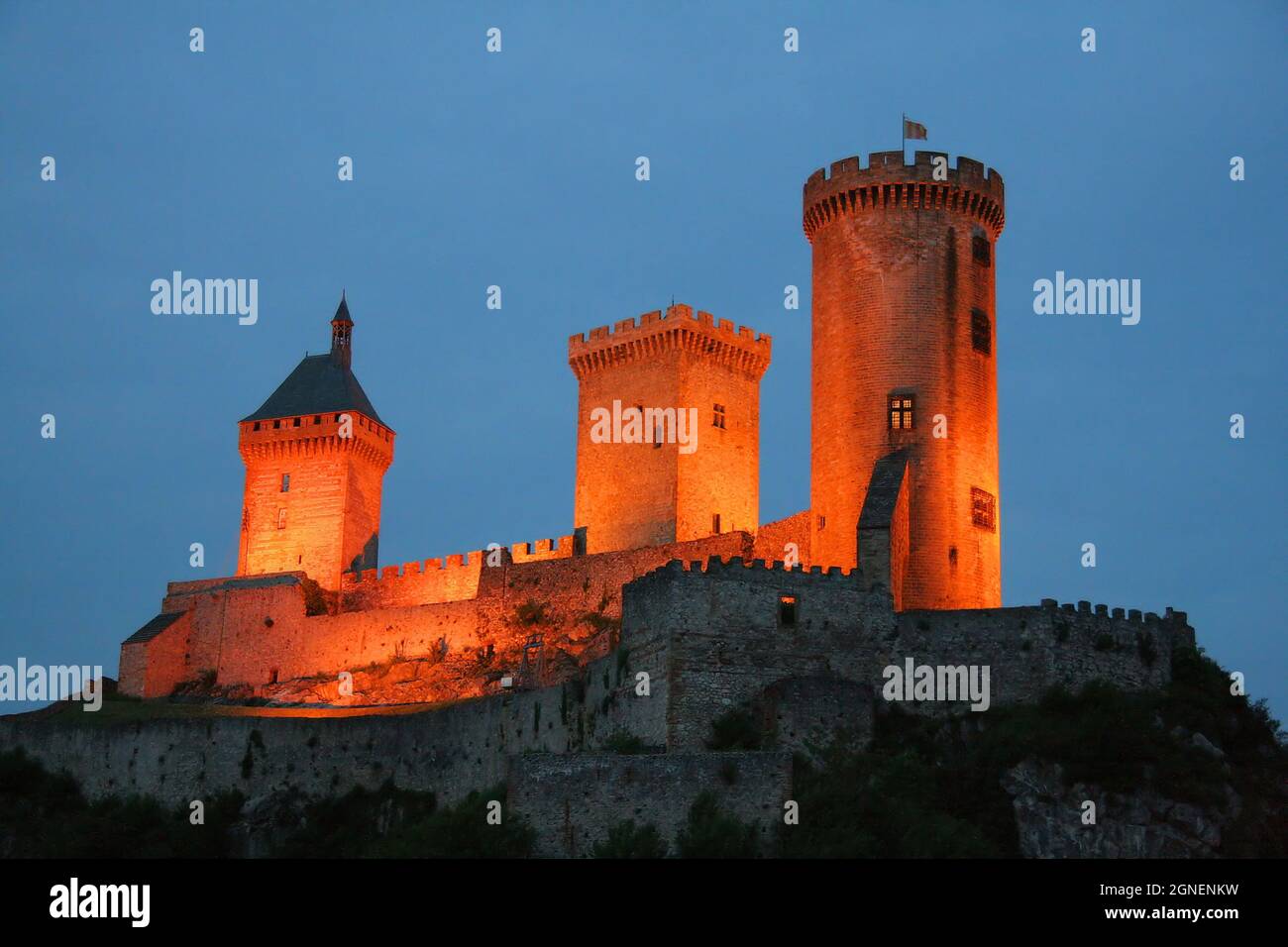 Foix Castle illuminated orange at dusk in Foix, Ariege, Pyrenees ...