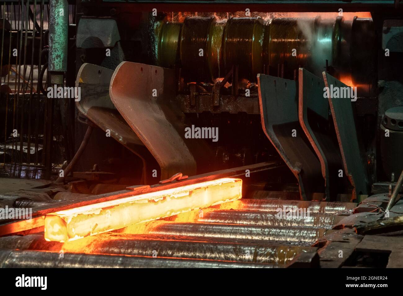 Red-hot metal billet on the roller table of a rolling mill Stock Photo ...