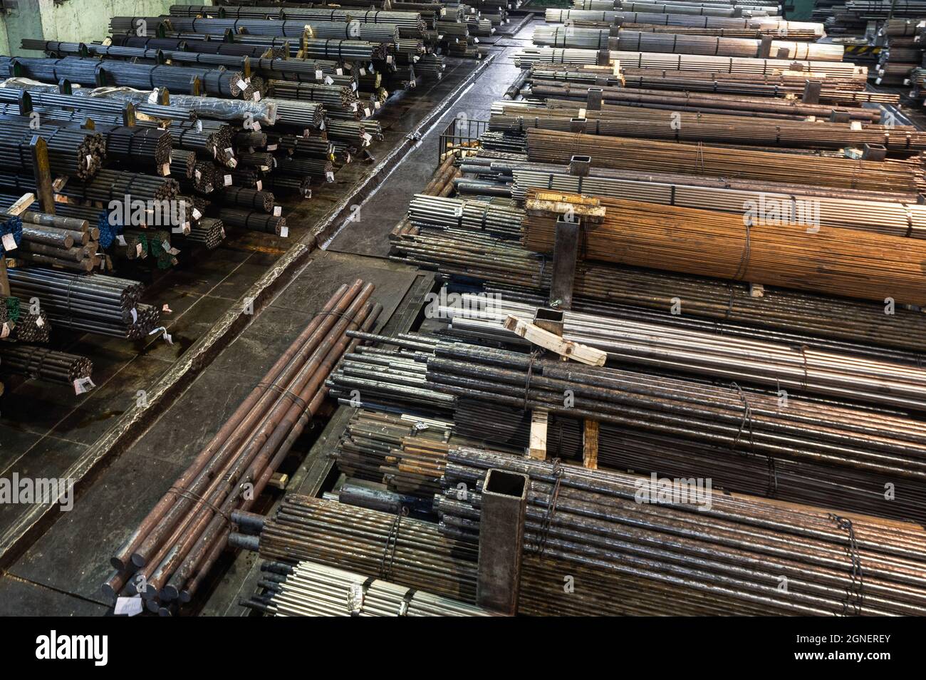 Rolled metal warehouse. Many packs of metal bars on the shelves Stock ...