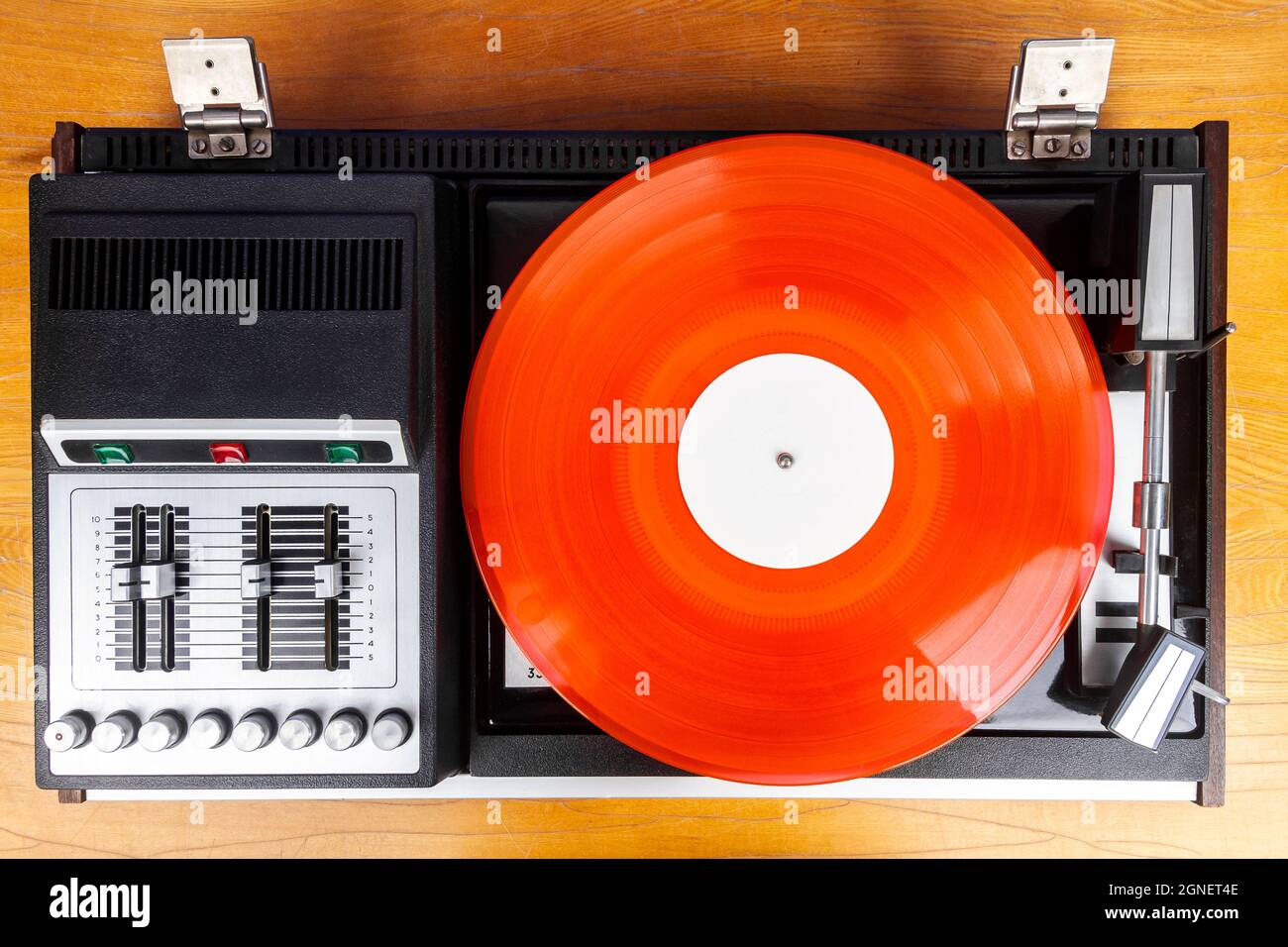 Vintage turntable vinyl record player with red vinyl on a table Stock ...
