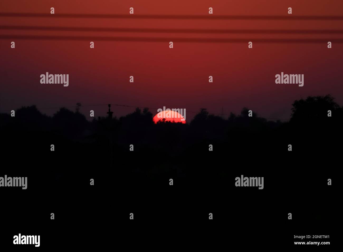 view of full round yellow bright sun and dim sunlight,Sunset behind ...