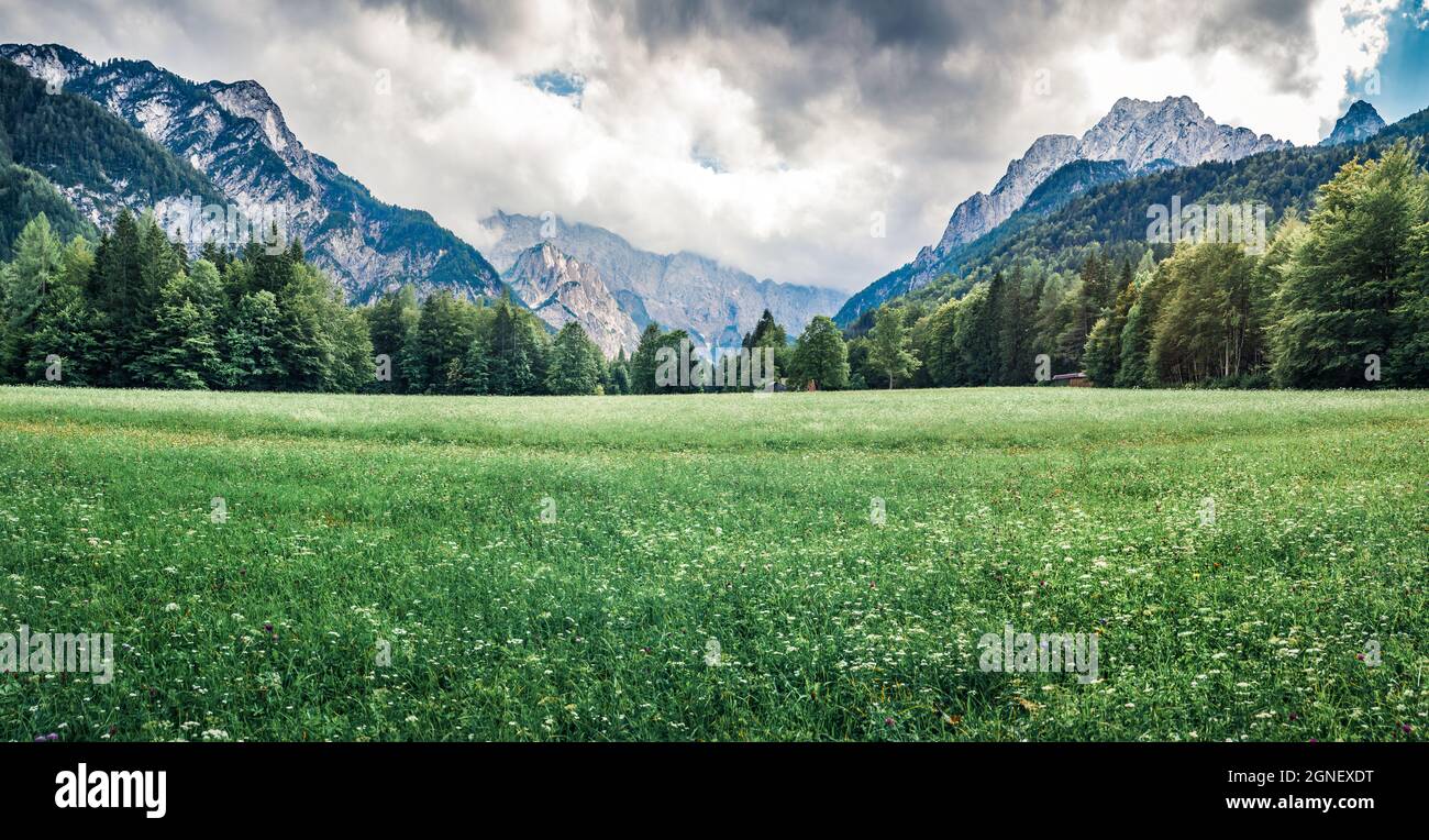 Dramatic summer panorama of Triglav mountain range. Gloomy mporinng ...