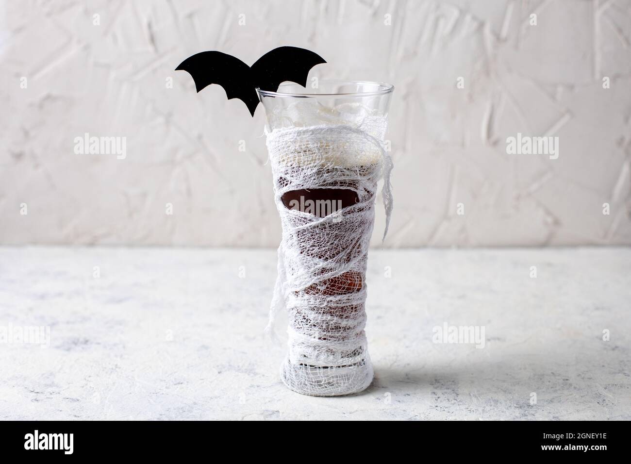 Glass of cocktail decorated as mummy. Drink for a halloween party for ...