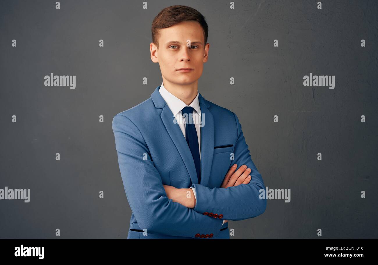 handsome business man in suit folded his hands in front of him work ...