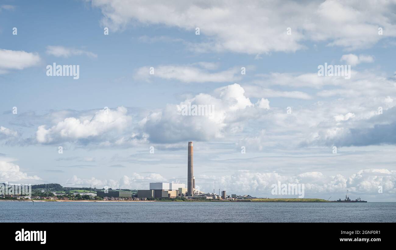 Large factory or plant with tall chimney and industrial harbour on the ...