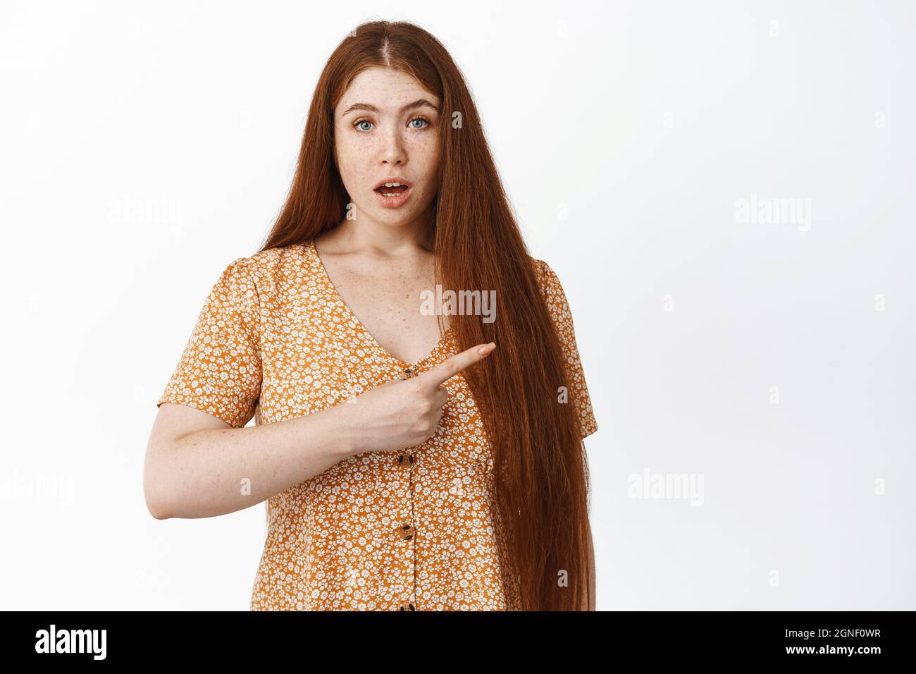 Surprised redhead girl asks question and points right at product ... Surprised redhead girl asks question and points right at product ...