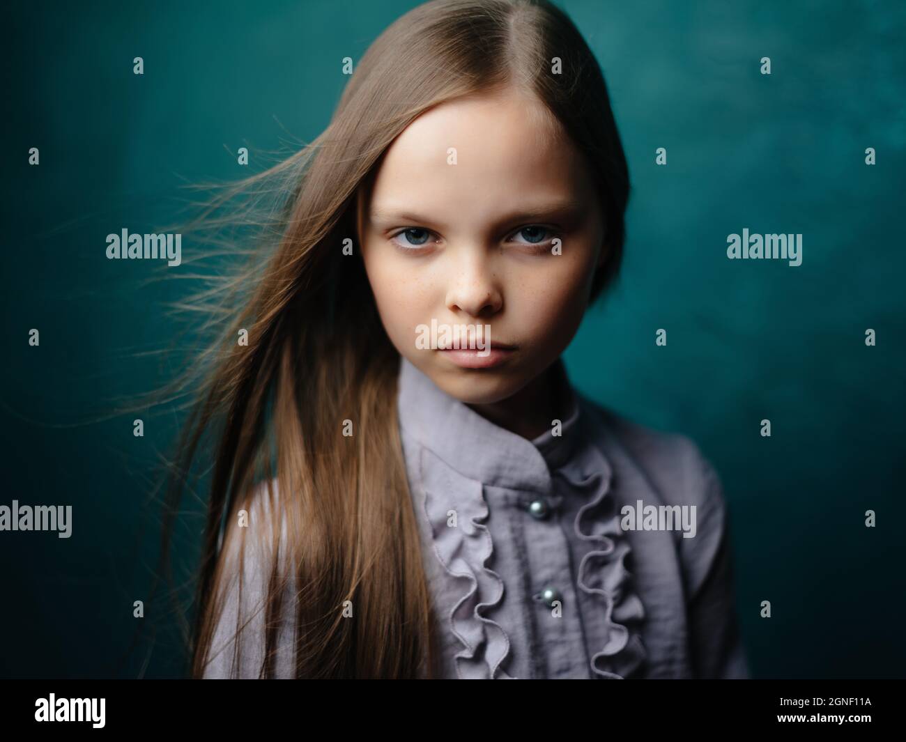 Girl in dress long hair studio green background close-up Stock Photo - Alamy