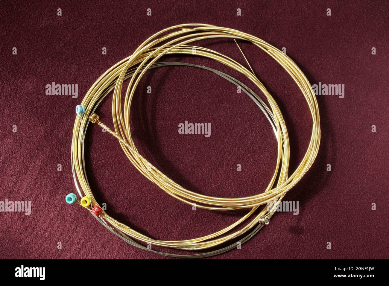 new and bronze guitar string Stock Photo - Alamy