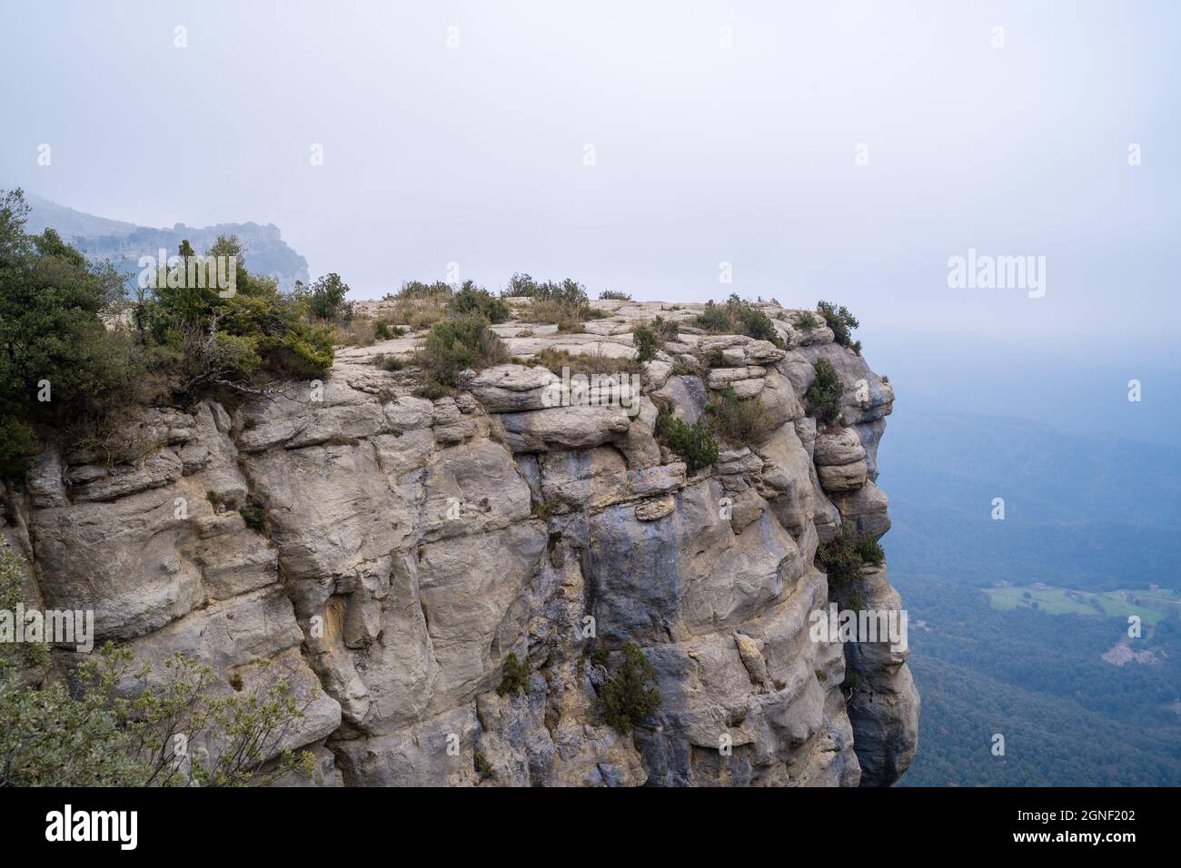 Gray rock cliff with yellow spots of tavertet with haze in the ...