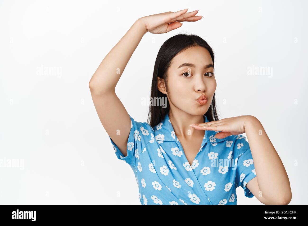 Close up of cute asian woman shaping box on head and showing her cute ...