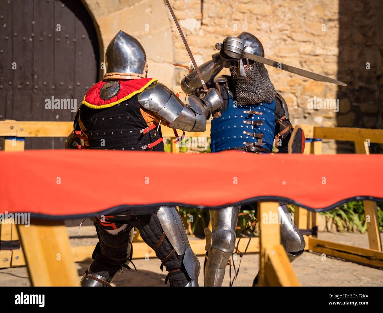 medieval knights dueling, blue knight attacking profight tournament in ...
