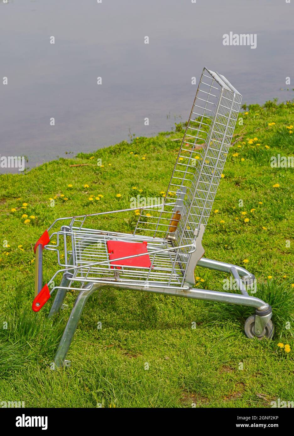 Armchair made from recycled shopping cart at grass coast Stock Photo ...