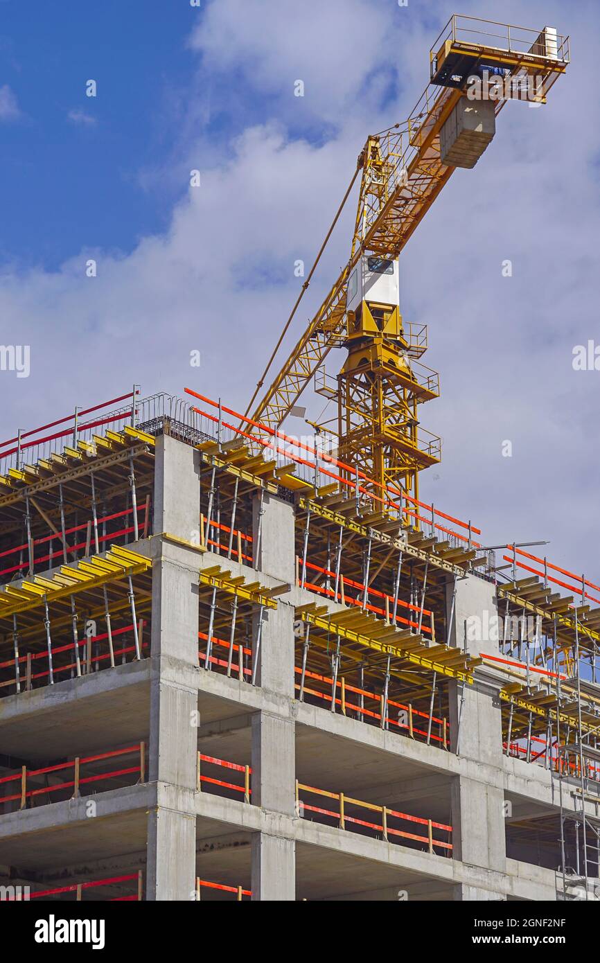 Crane and scaffolding forms at concrete building construction site ...