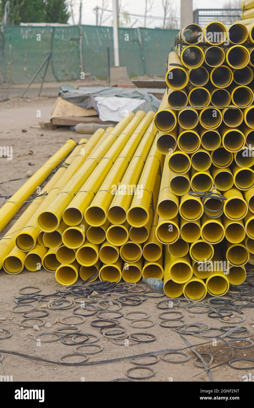 New yellow pipes material at construction site Stock Photo - Alamy