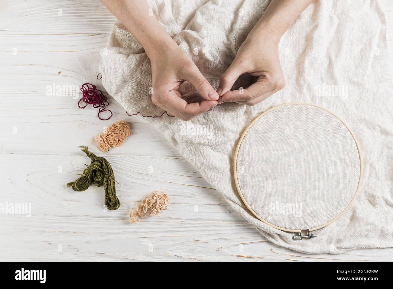 hand holding needle thread tambour frame. High quality and resolution ...