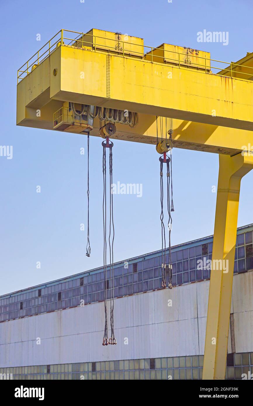 Big yellow gantry crane in shipyard over industrial building Stock ...