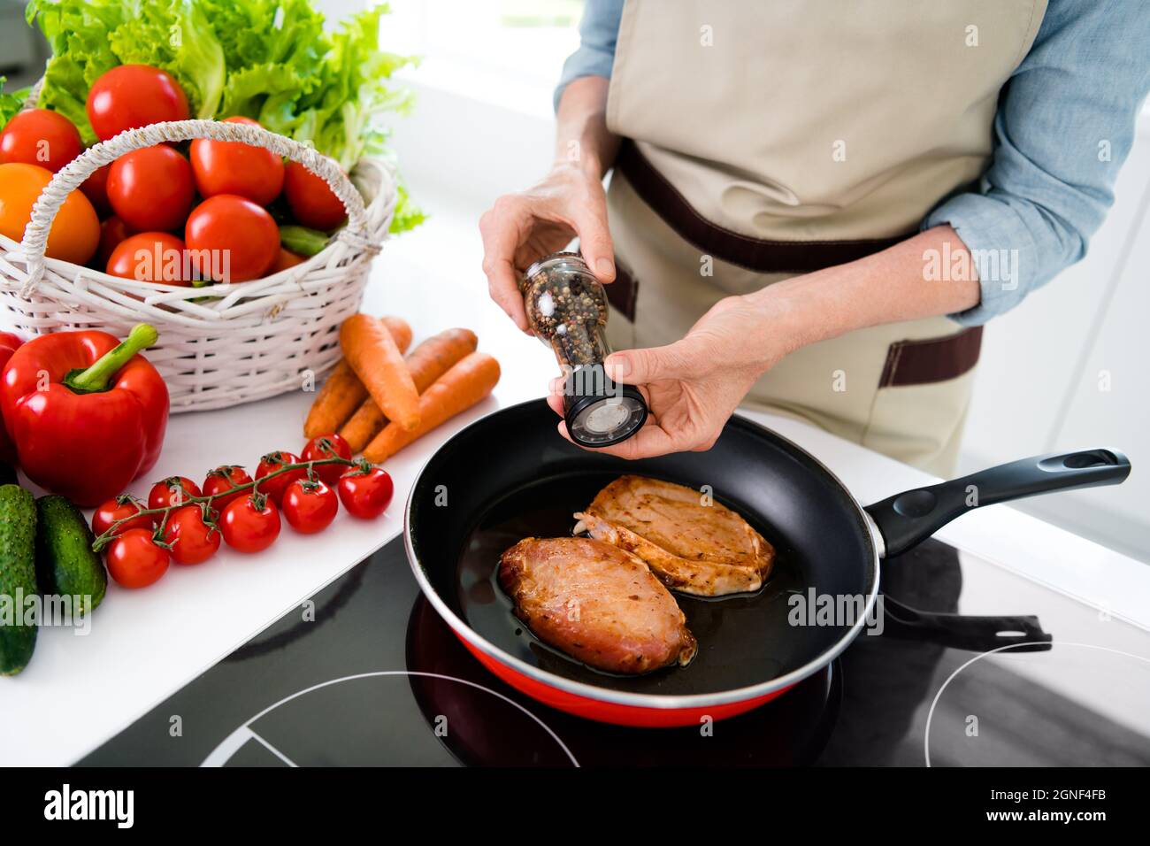 Cropped photo of mature lady cook meat wear apron jeans shirt at ...