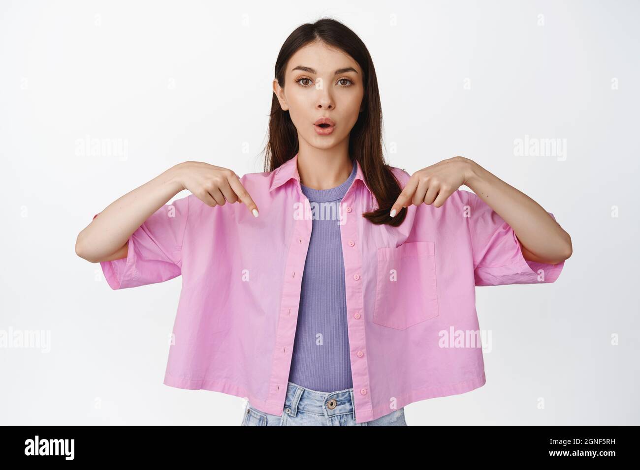 Wow look down. Image of caucasian brunette girl pointing fingers below ...