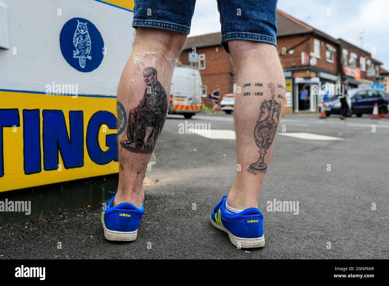 Leeds, UK. 25th Sep, 2021. A fan outside Elland Road Stadium shows off ...