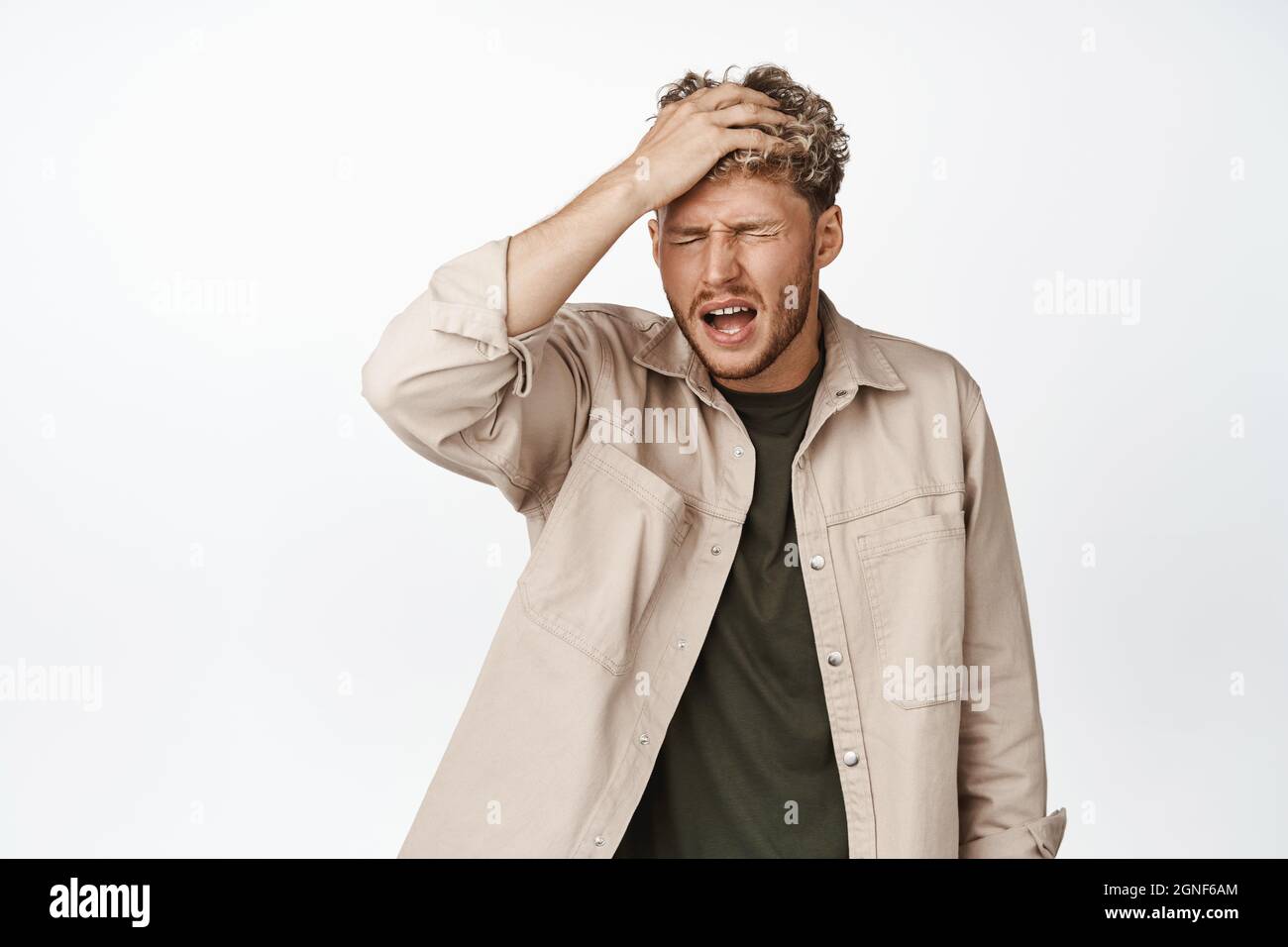 Upset young man slap his forehead forgetful gesture, forgot something ...