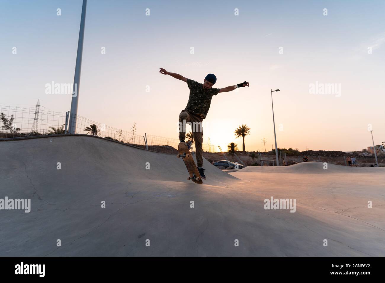 young skater man does a trick called ollie at sunset. movement 2 Stock ...