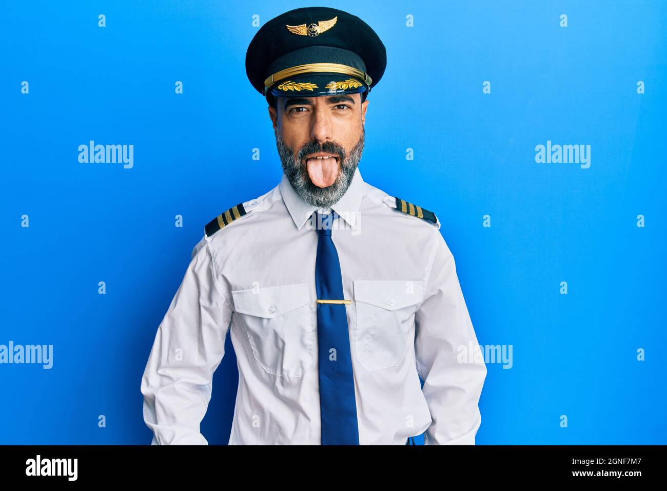 Middle age man with beard and grey hair wearing airplane pilot uniform ...