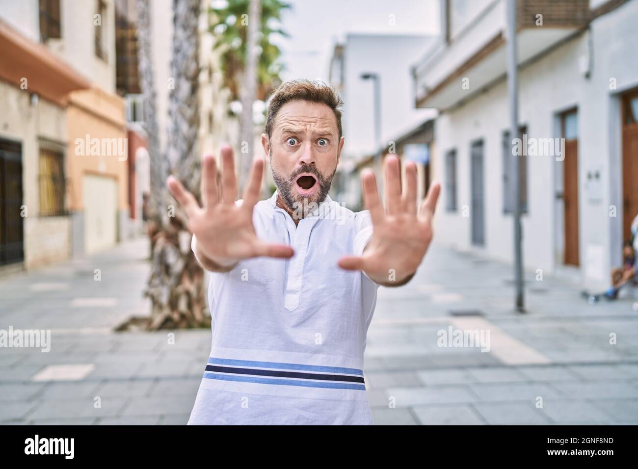 Middle age man outdoor at the city afraid and terrified with fear ...