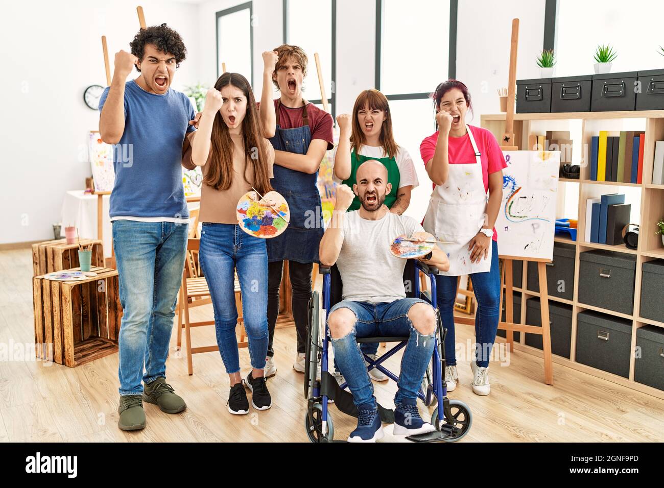 Group of young artists people at art studio annoyed and frustrated ...