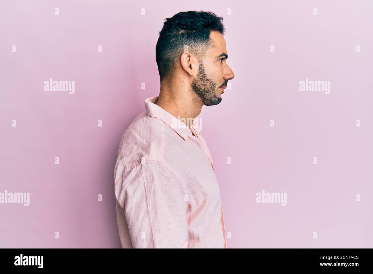 Young hispanic man wearing casual clothes looking to side, relax ...