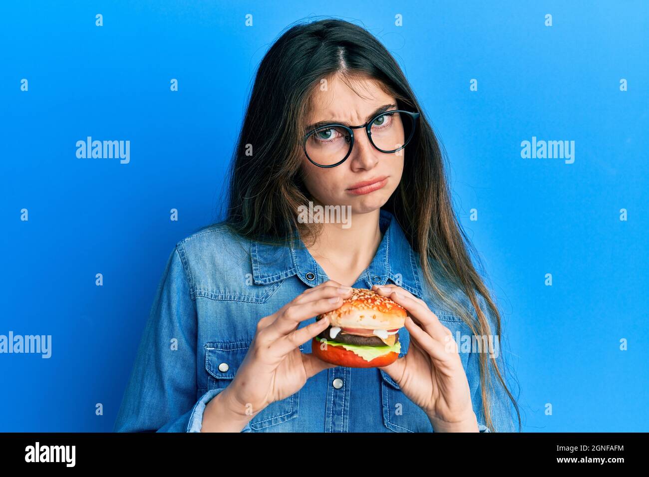 Nervous person eating hamburger hi-res stock photography and images - Alamy