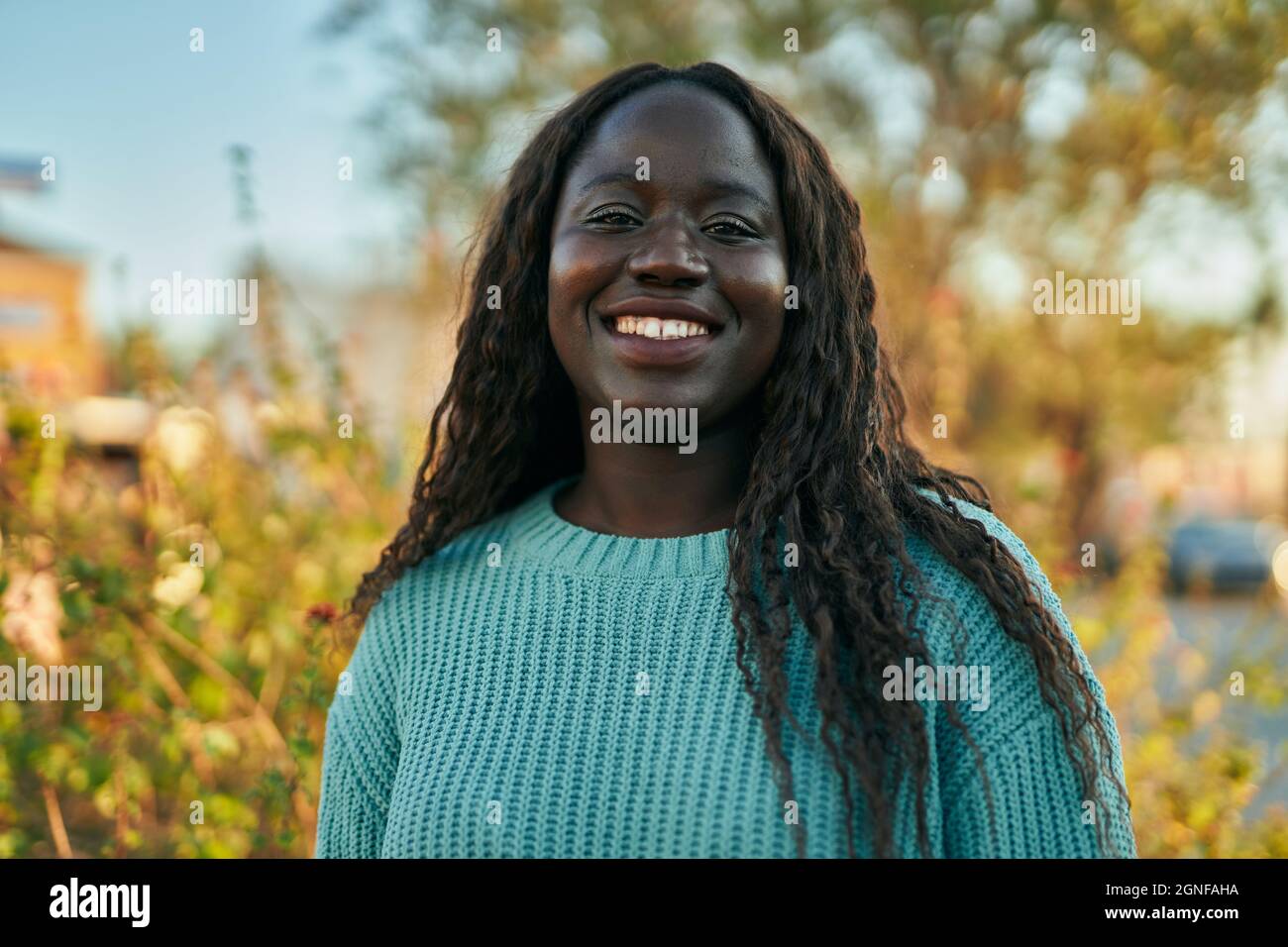 Young african woman smiling happy at the park Stock Photo - Alamy