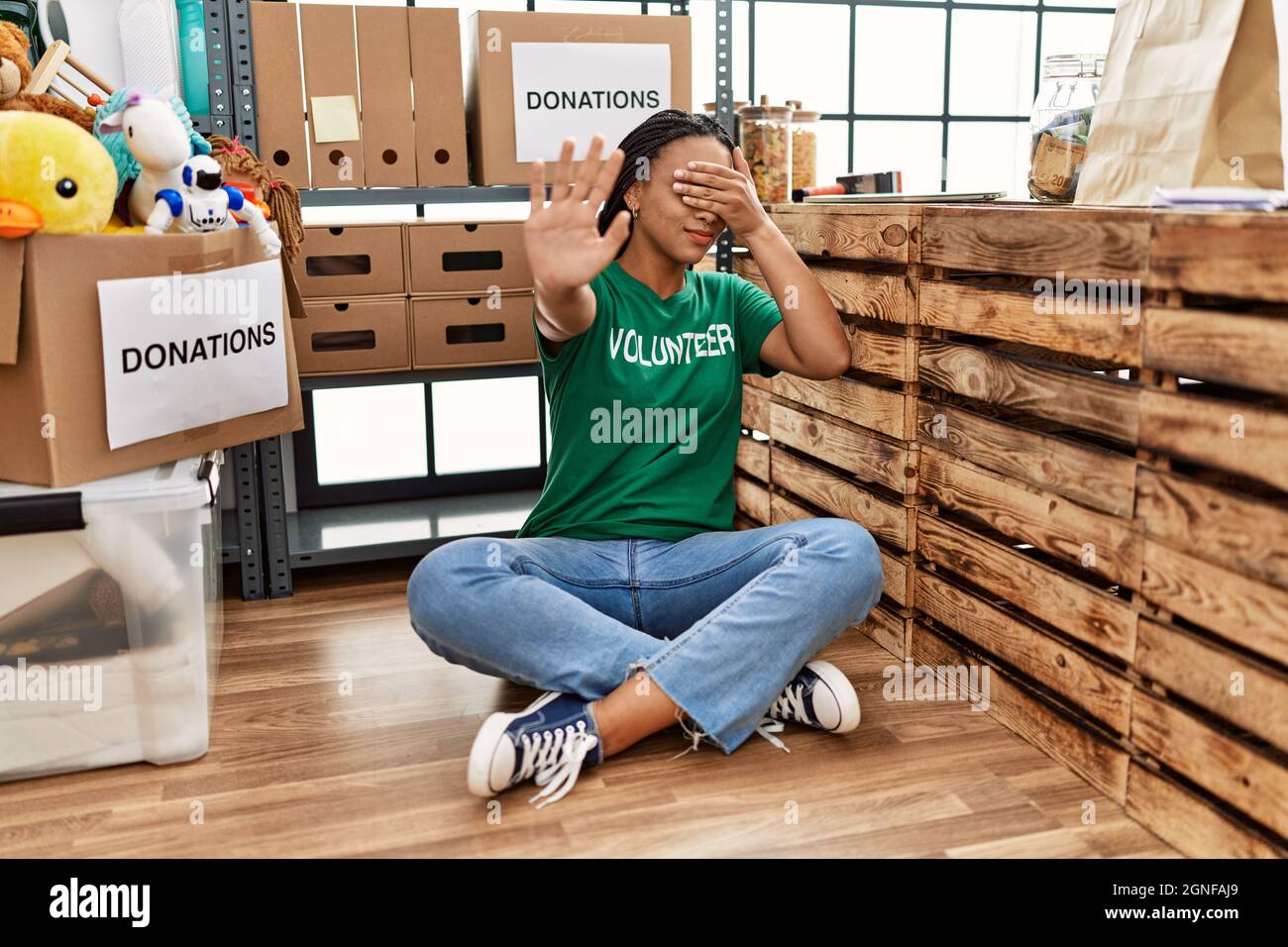 Young african american woman wearing volunteer t shirt at donations ...