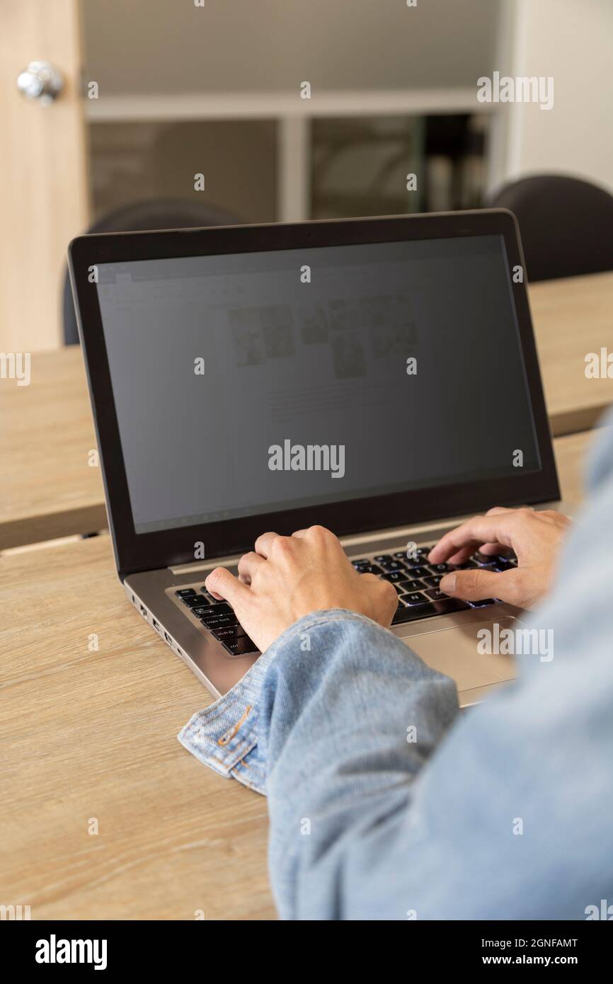 details of a person's hands typing with a keyboard a computer, detail ...