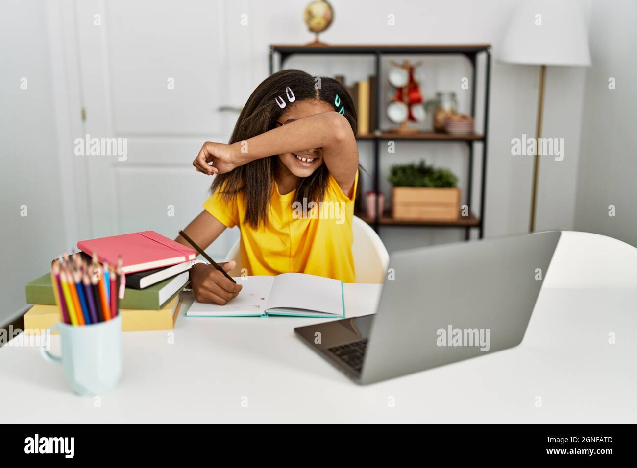 Young african american girl doing homework at home smiling cheerful ...