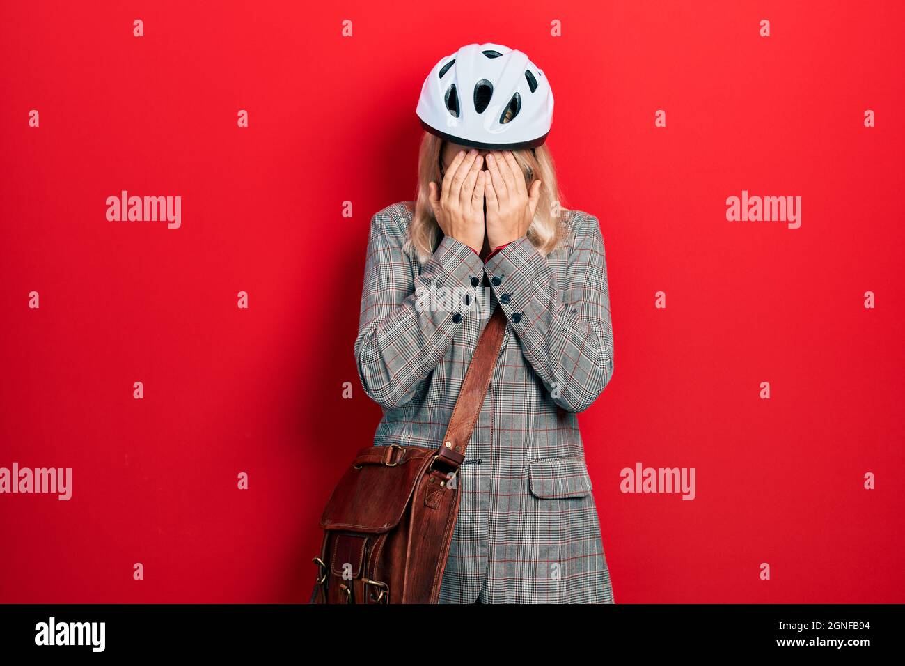 Beautiful caucasian blonde business woman wearing bike helmet with sad ...