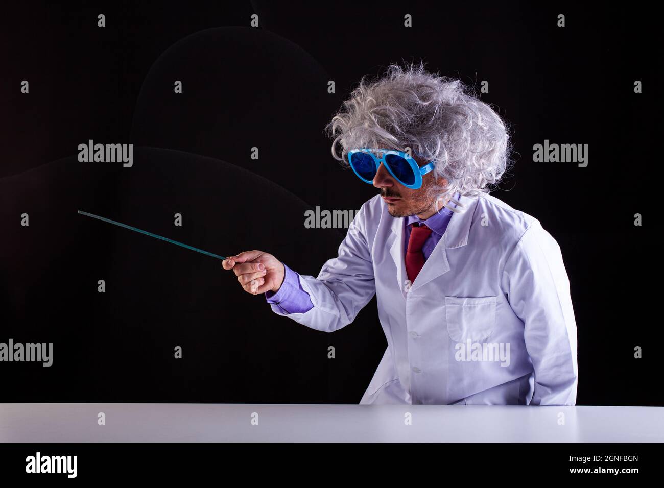Crazy science teacher in white coat with unkempt hair in funny eye ...