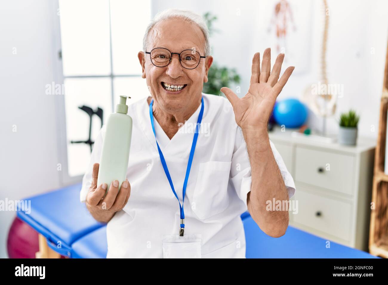 Senior physiotherapy man holding massage body lotion celebrating ...