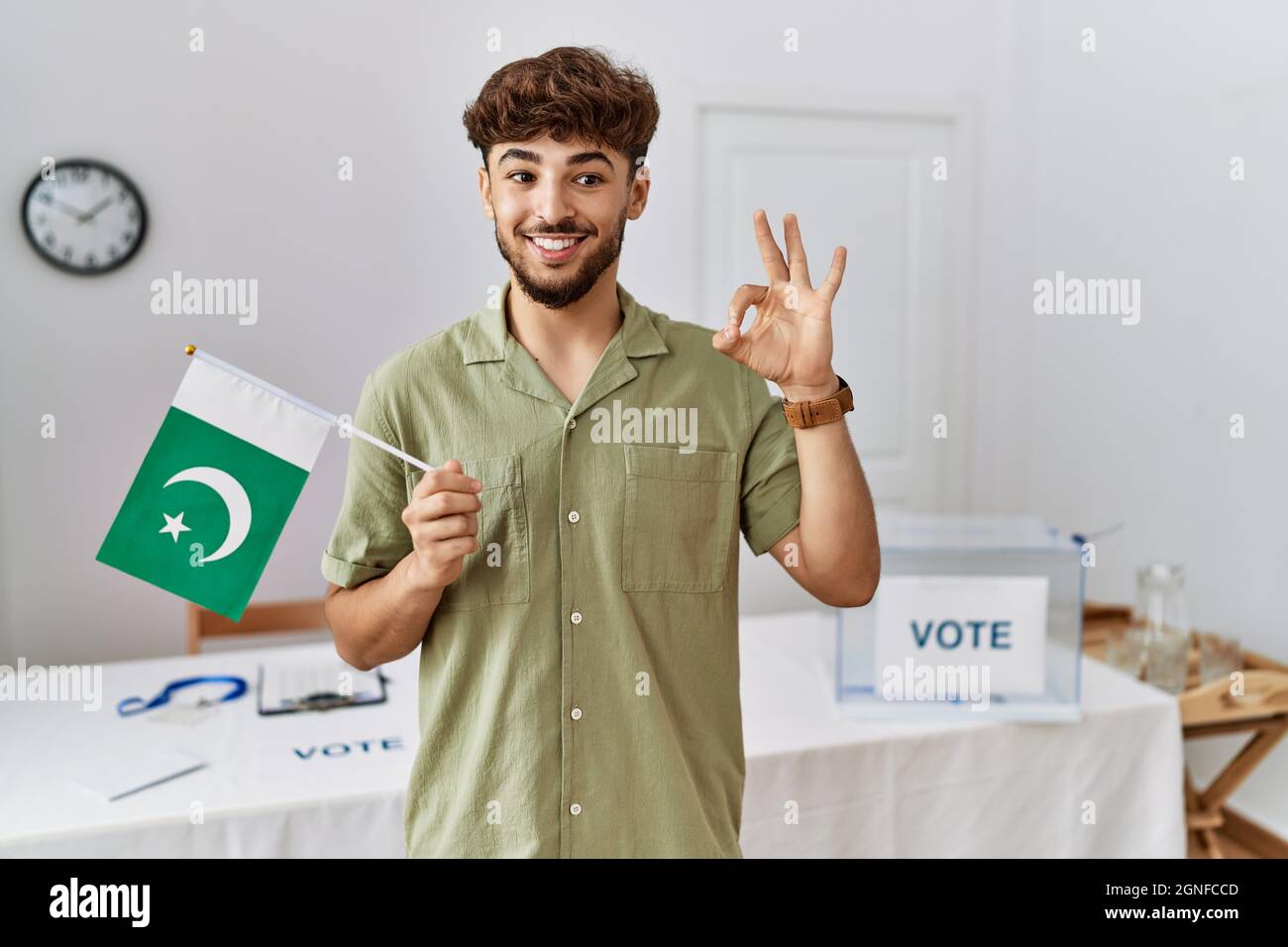 Young arab man at political campaign election holding pakistan flag ...