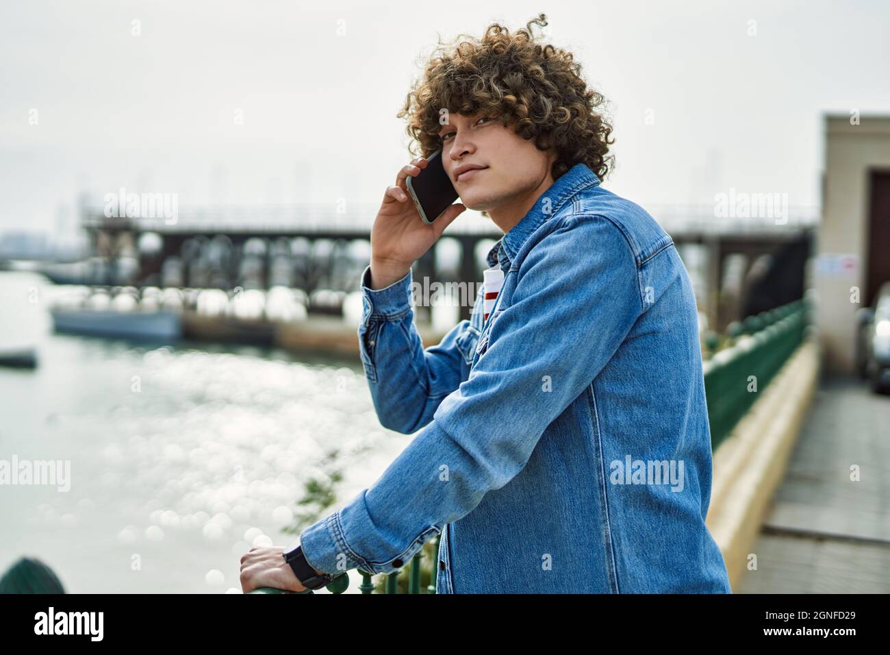 Young hispanic man speaking on the phone at marina port Stock Photo - Alamy