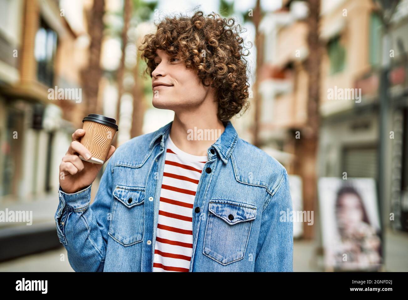 Young hispanic man drinking take away cup of coffee at the city Stock ...