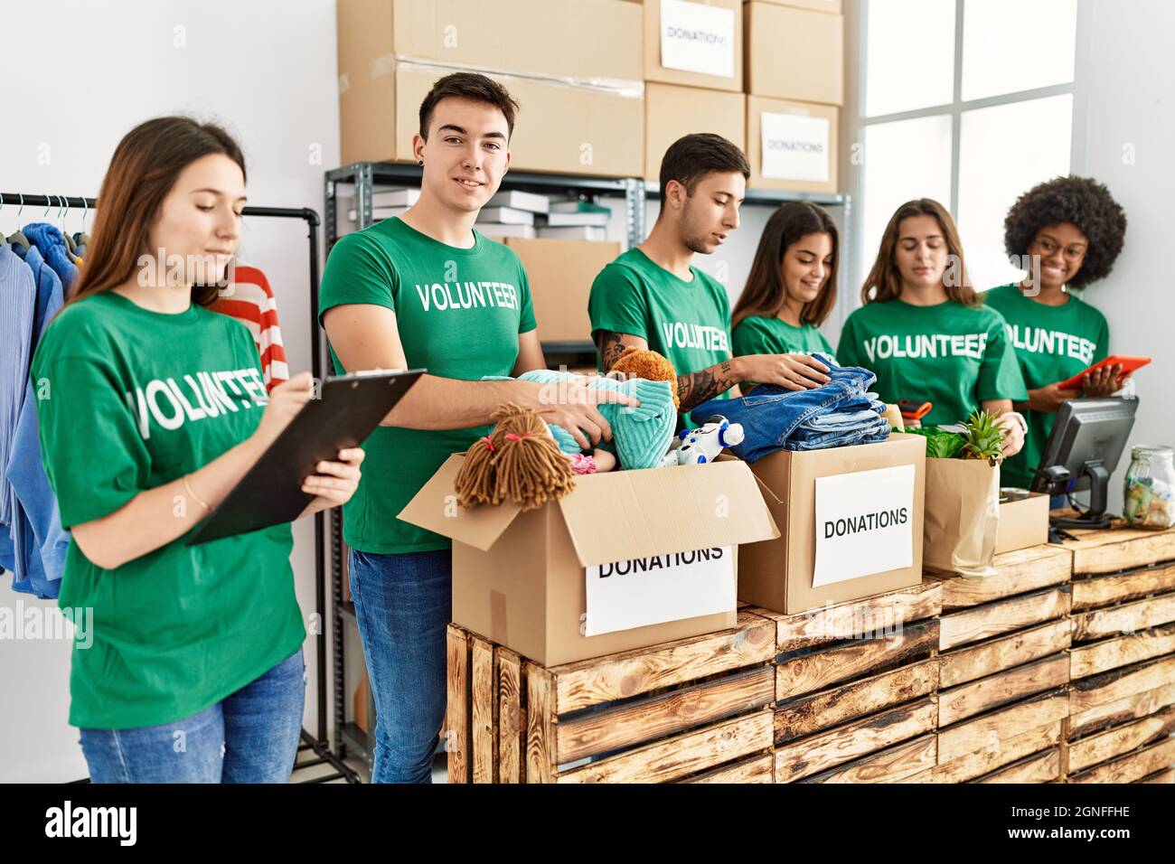 Group of young volunteers smiing happy working at charity center Stock ...