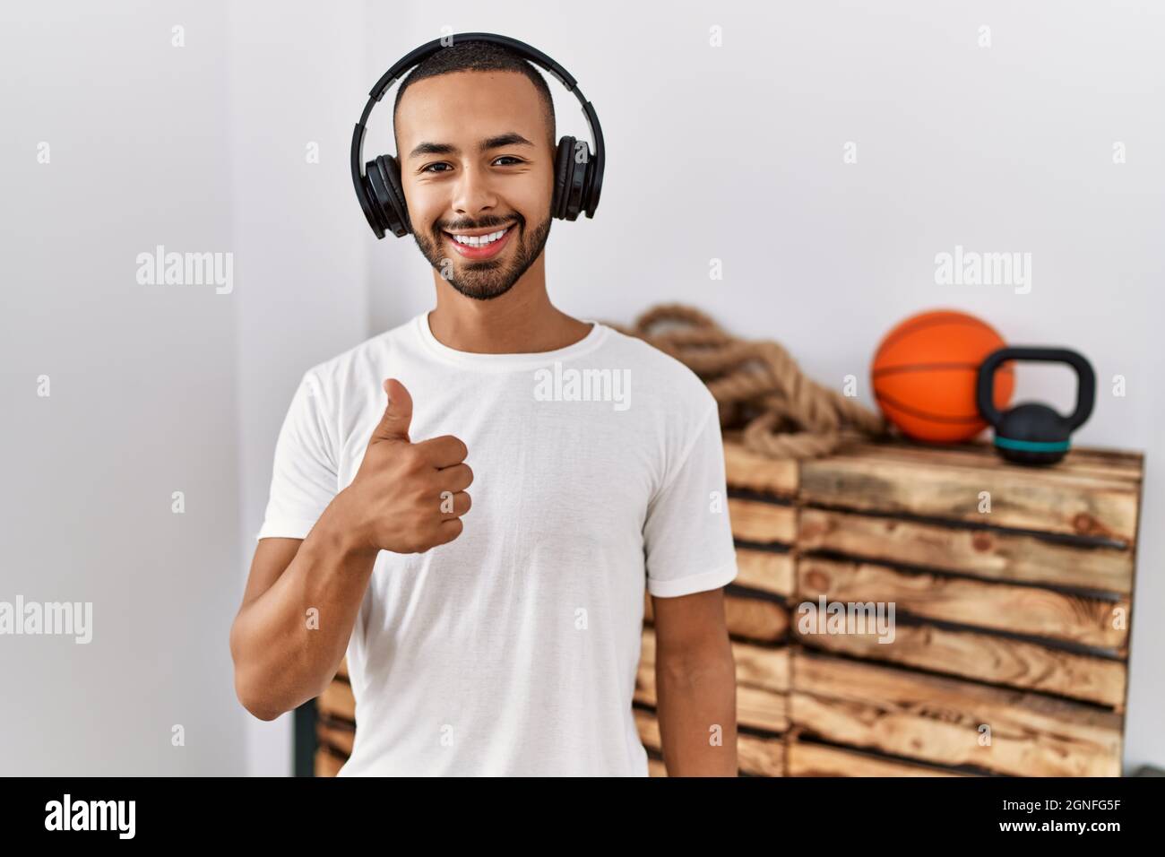 African american man listening to music using headphones at the gym ...